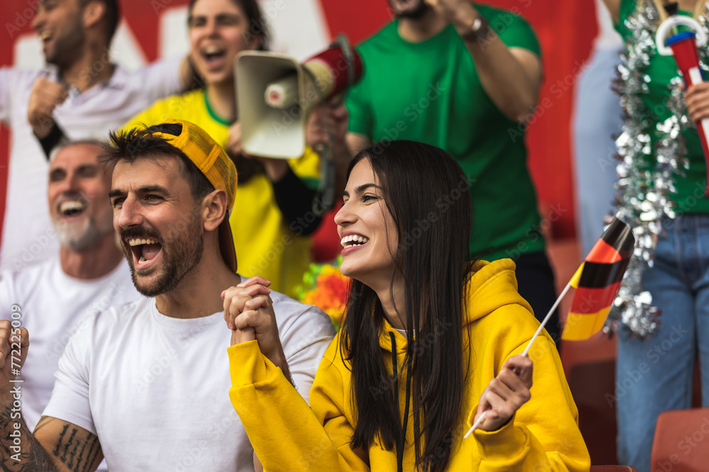 German football / soccer fans cheering at the stadium with flags and ...