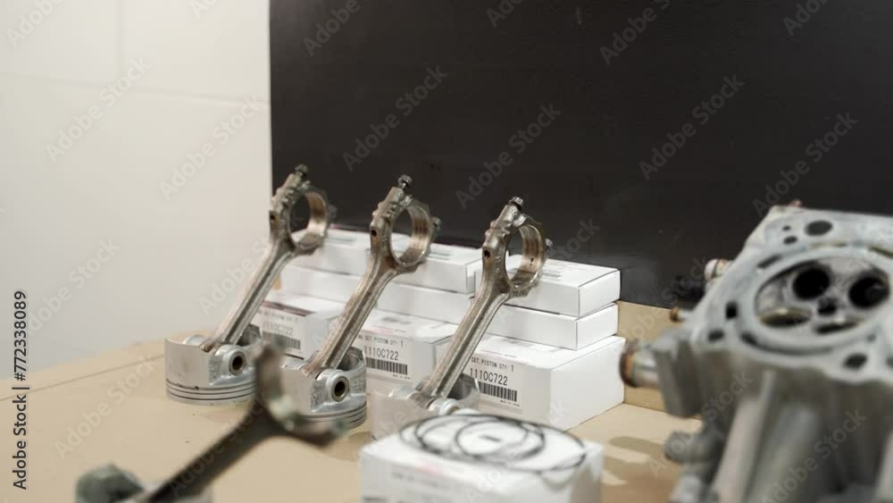 Auto repair shop, engine parts for overhaul. Mechanic prepares cylinder ...