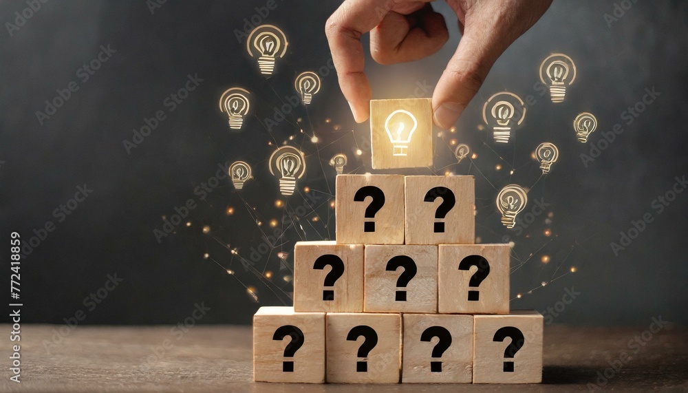 Hand put the last wooden cubes on the top of a pyramid built by wood ...