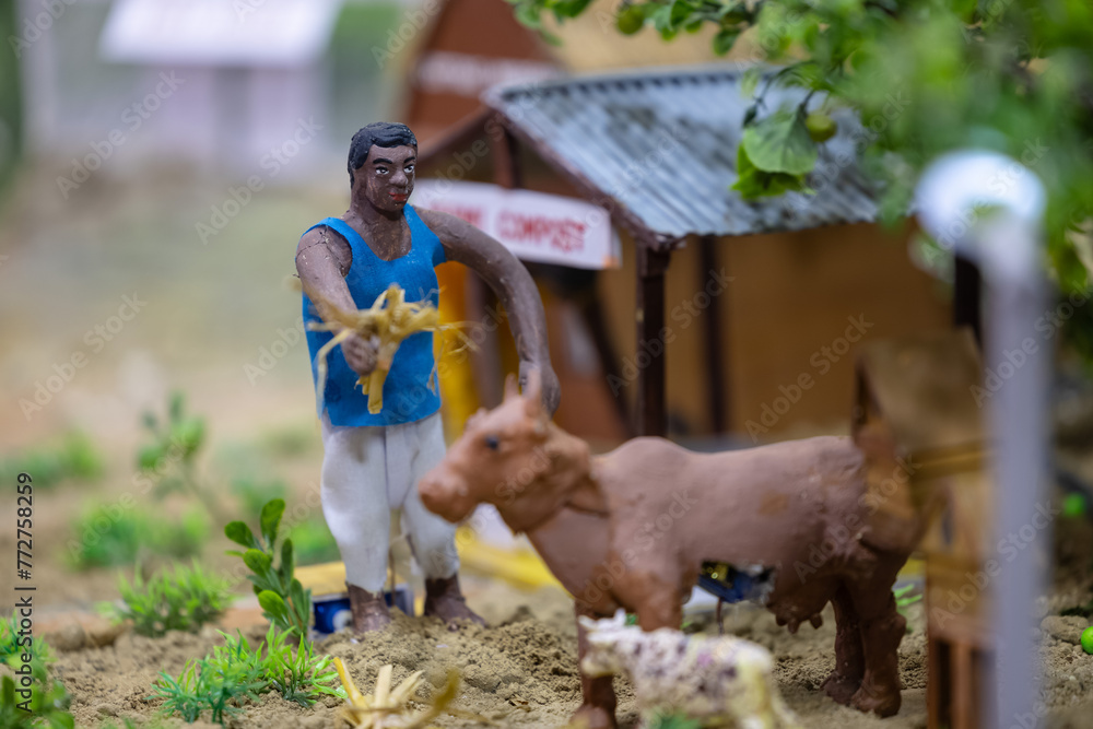 Handmade idol of indian farmer while working in farming field made with ...