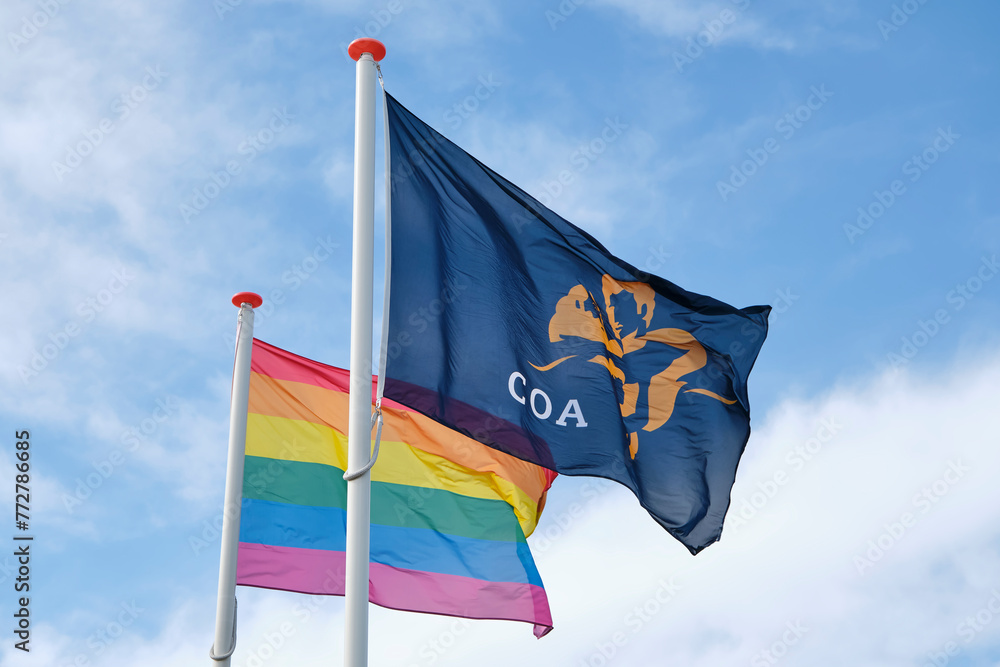 Flag of the COA and a rainbow flag at the entrance of a temporary ...