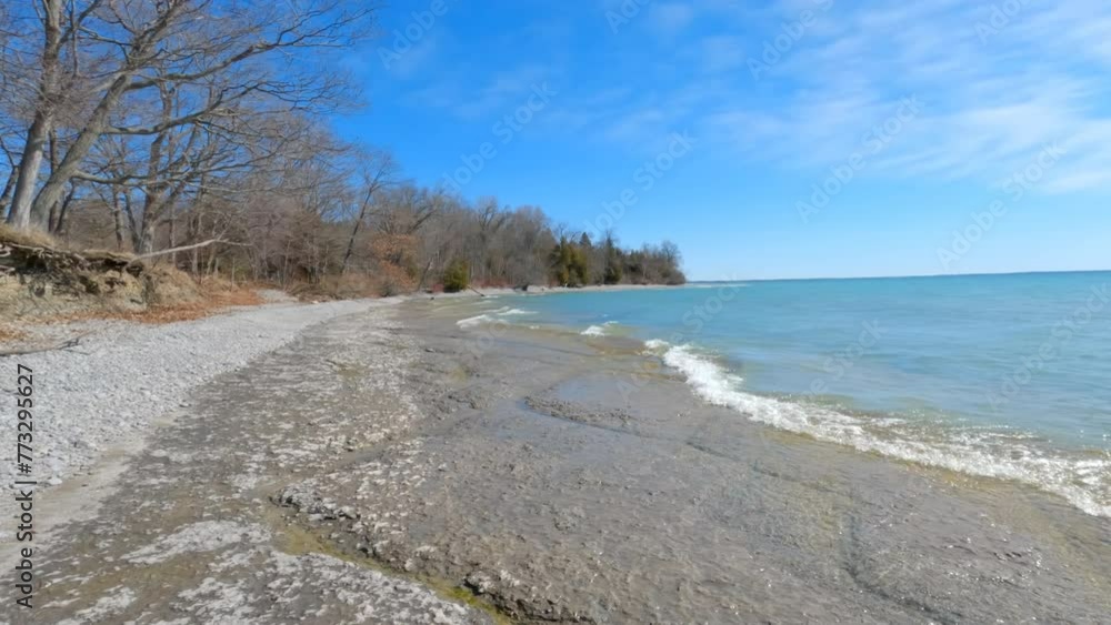 Panning from the sedimentary limestone beach to the turquoise blue ...