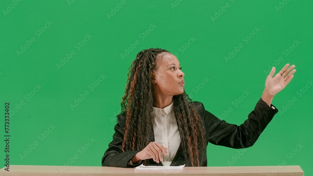 Female reporter at the desk isolated on chroma key green screen ...