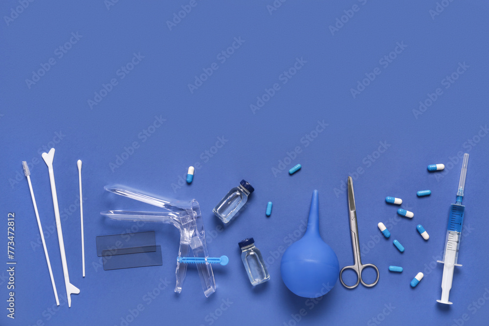 Gynecological speculum with pap smear test tools, pills and ampules on ...