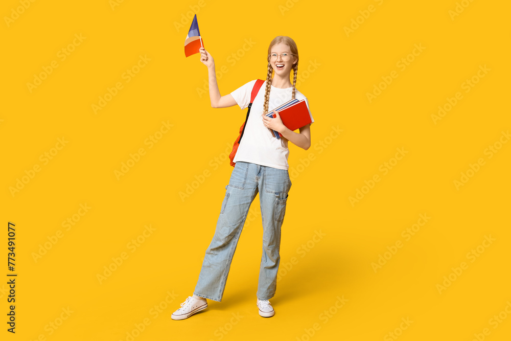 Female student with French flag and books on yellow background Stock ...