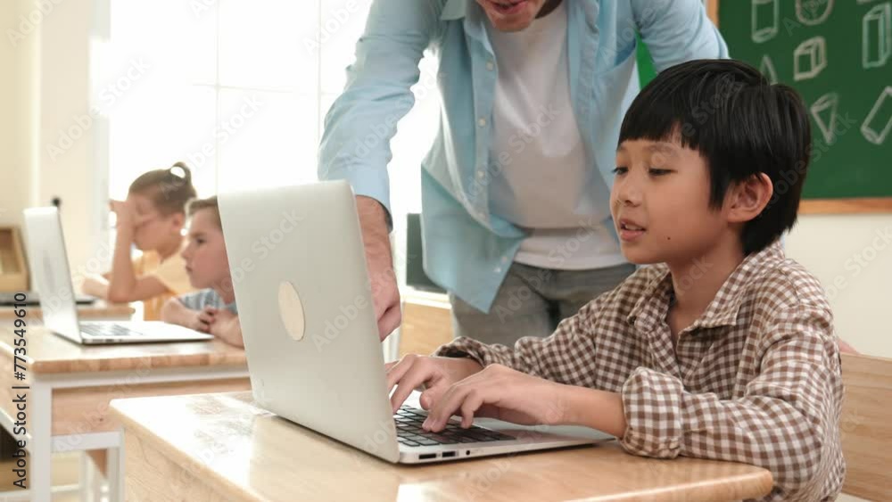 Caucasian teacher helping asian student coding engineering prompt while diverse student using ...