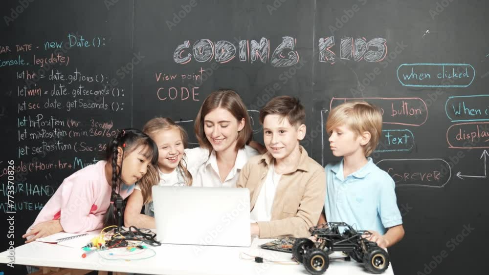 Smart teacher and diverse student looking at laptop on table with car ...