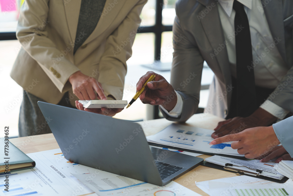 Team work process Business team use calculator to calculate figures ...