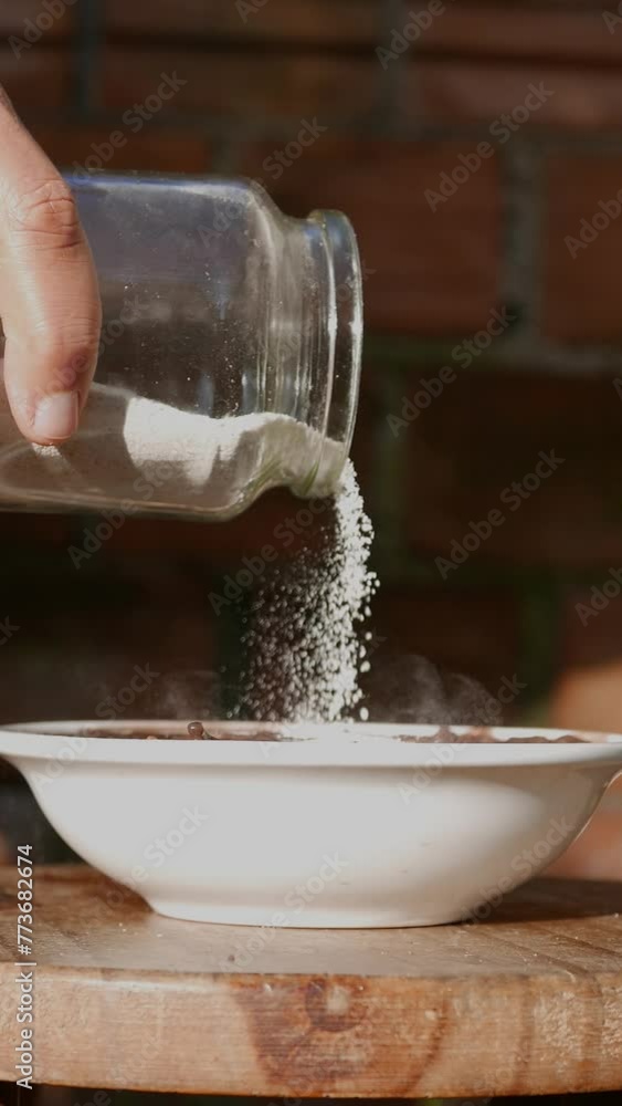 Pouring cassava flour into a hot bean stew plate. A hot bean bowl ...