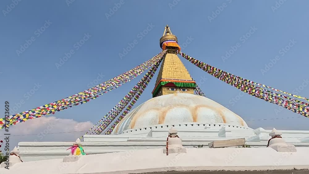 circling around Large emblematic Stupa with eyes and prayer flags ...