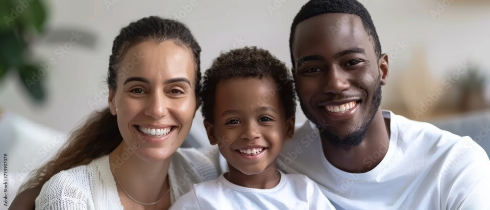 An international family poses at home with their biracial preschooler ...