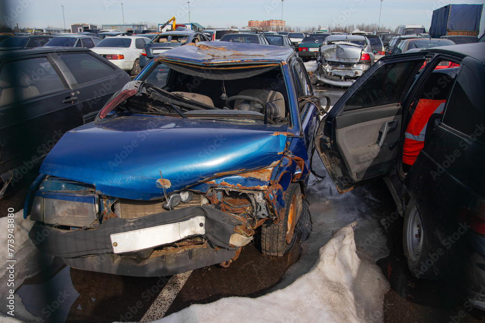 Broken and burnt cars after road accidents stand in a special parking ...