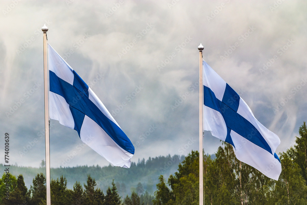 Flag of Finland with dramatic beautiful storm sky with dark clouds and ...