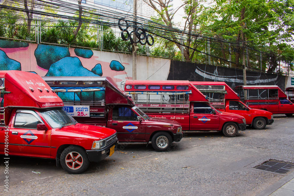 Bangkok, Thailand - 28 December, 2023: Row of red songthaew buses on ...