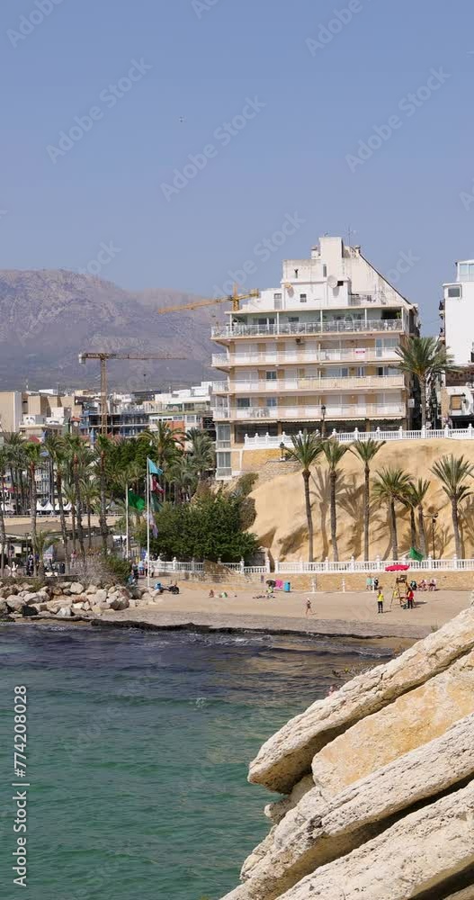 Portrait footage of the beautiful town of Benidorm showing the Cala del ...