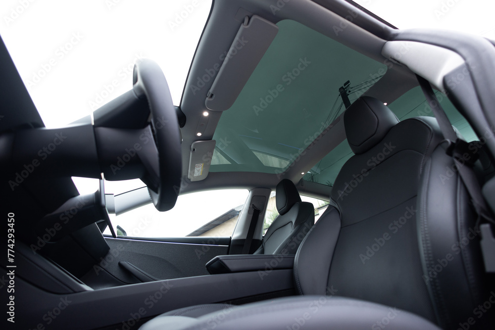 Panoramic glass sun roof in the new electric car. Clean glass and view ...