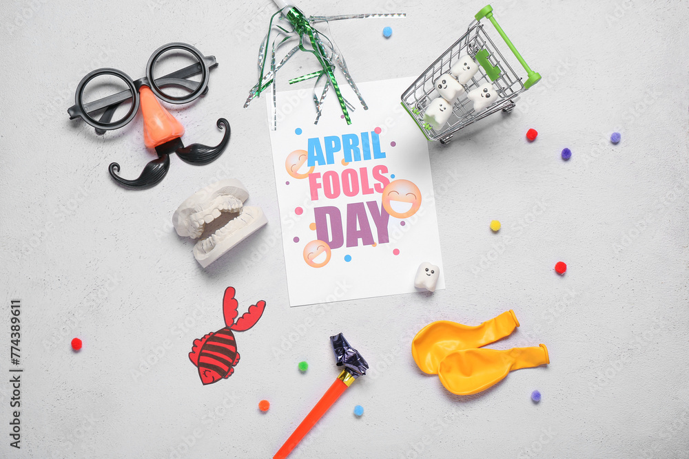 Card with text APRIL FOOLS DAY, jaw model, plastic teeth and party ...