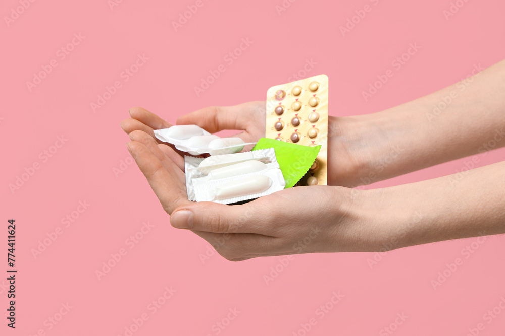Female hands with birth control pills, vaginal suppositories and ...