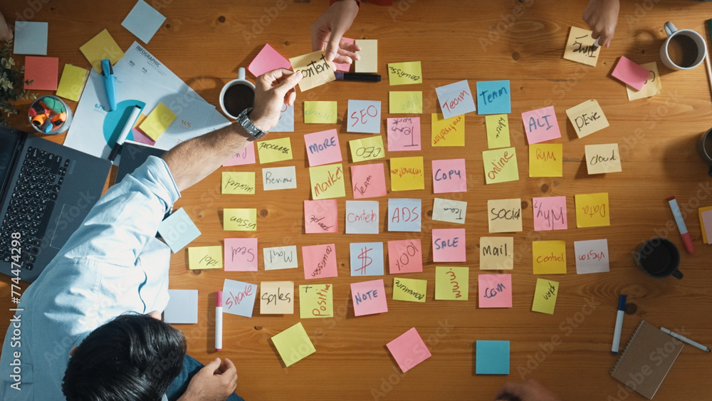 Top view of skilled business people discuss plan at meeting room while ...