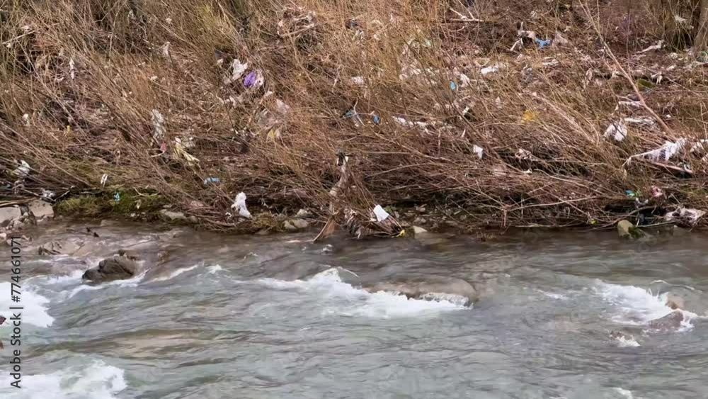 uncultured people throw garbage into the river, fast water carries ...