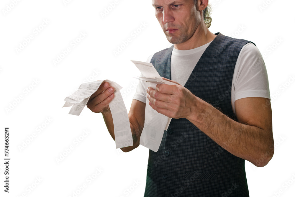 Frustrated young man with paper bills calculating monthly expenses ...
