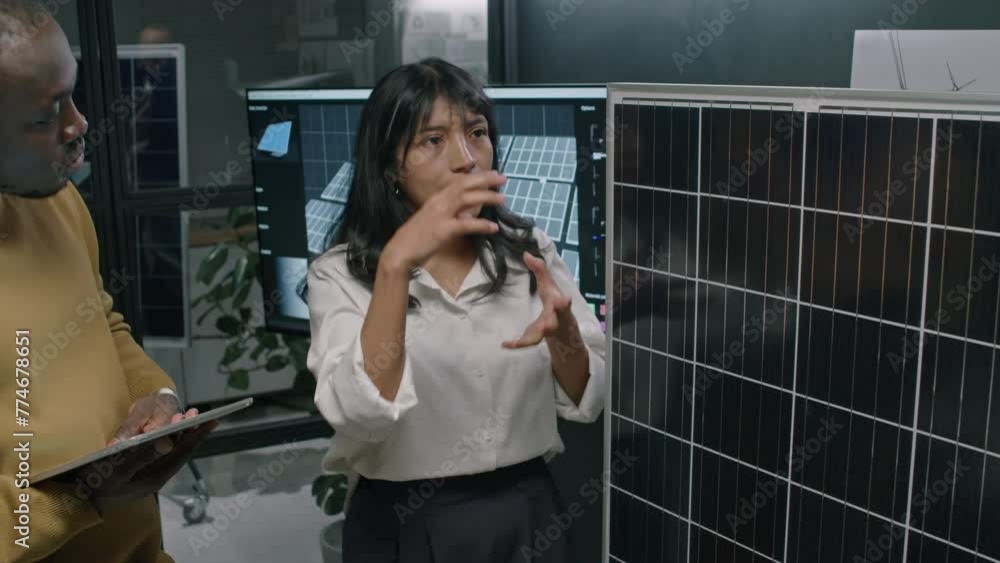Pull out footage of Hispanic woman explaining to diverse male ...