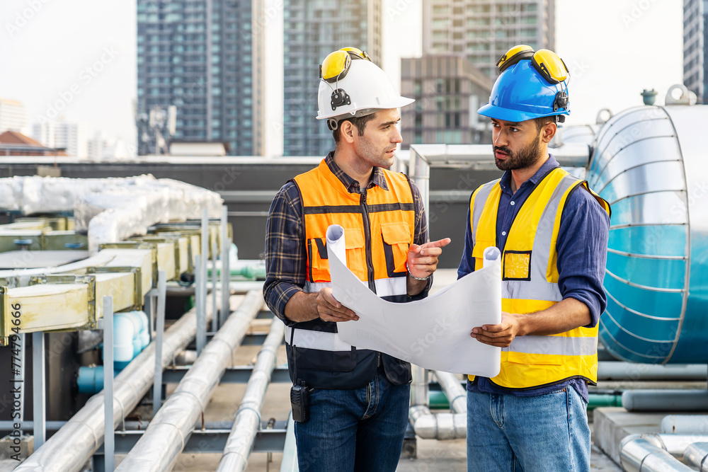 Contractor, Two civil engineers checking information from blueprint ...