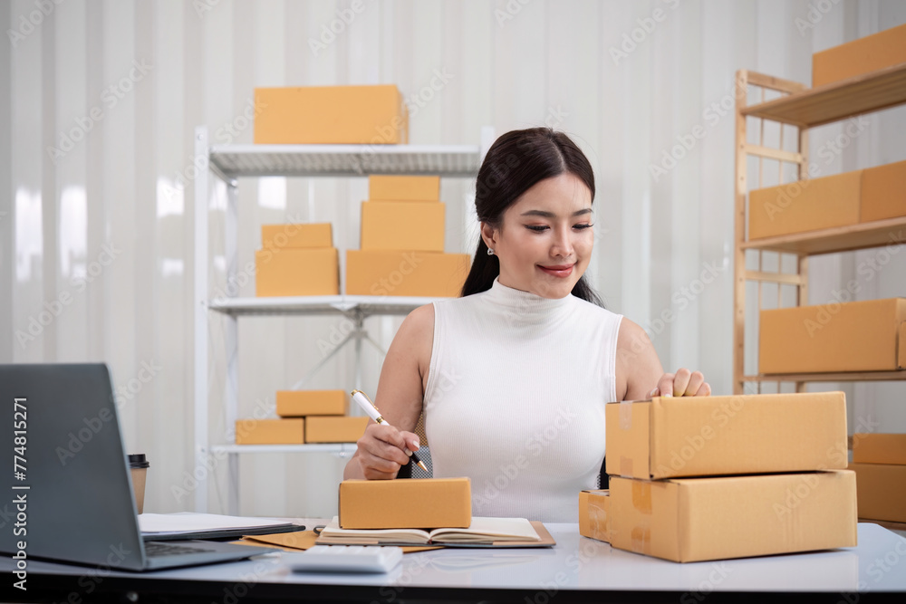 Young business woman asian working online ecommerce shopping at her ...