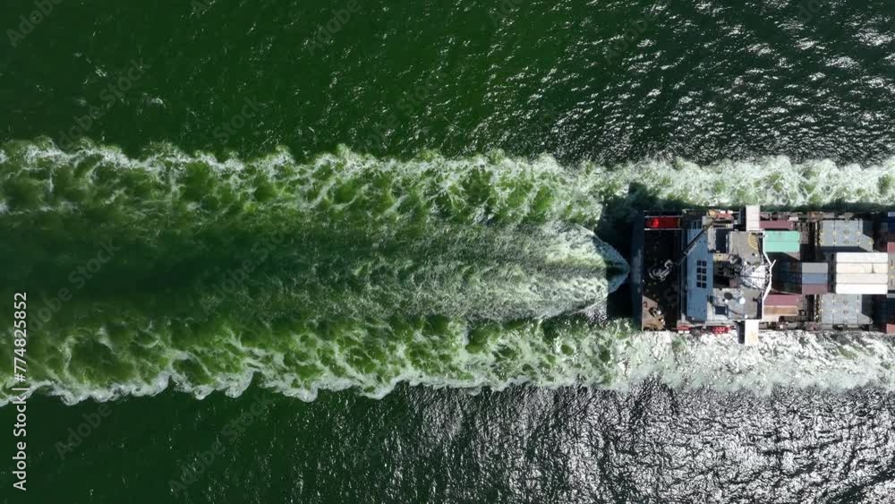 stern view of cargo maritime ship with contrail in the ocean ship ...