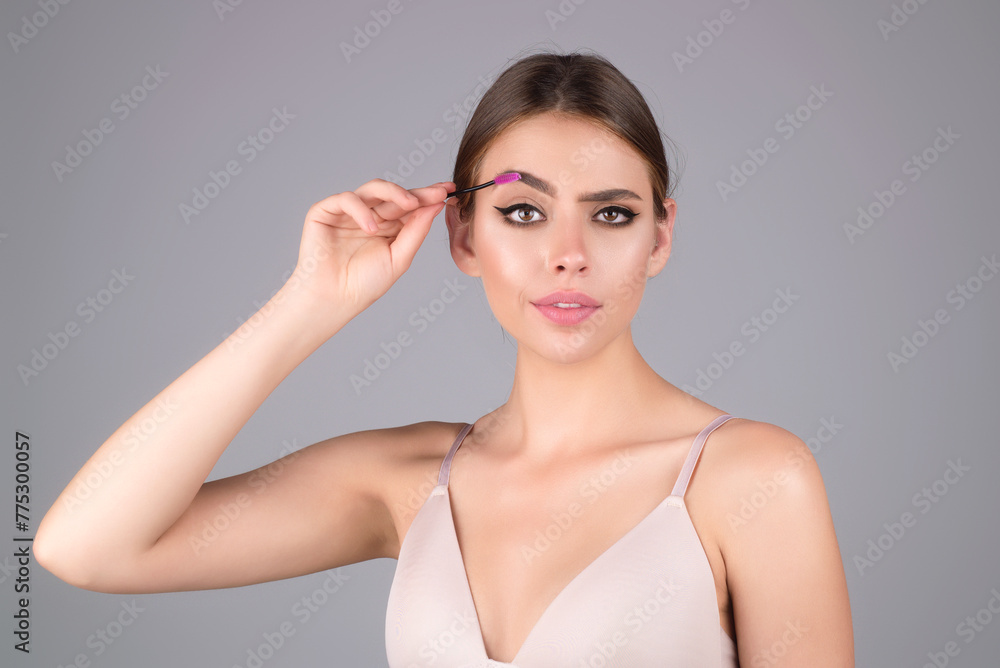 Woman shaping brown eyebrows. Woman eye with beautiful eyebrows. Shaped brows, long eyelashes ...
