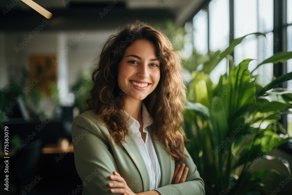 Smiling business girl in a modern open-plan office, natural light ...
