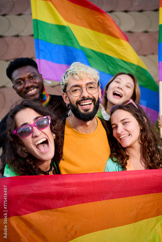 Vertical group of people are standing next to each other holding ...