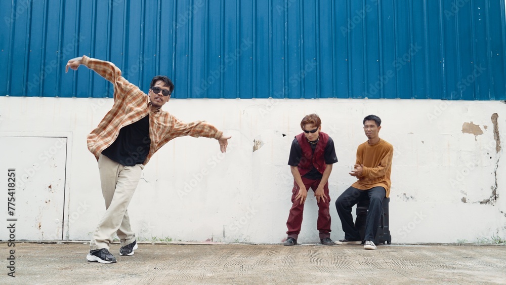 Young street dancer dancing in hip hop style with multicultural friends ...