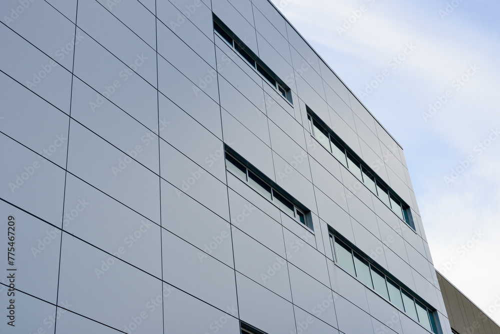 The exterior wall of a contemporary commercial-style building has ...