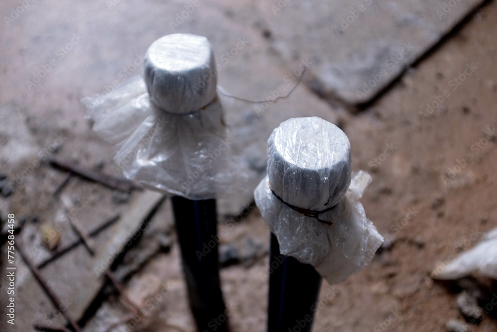 White PVC pipes protruding out of a floor in a construction project ...