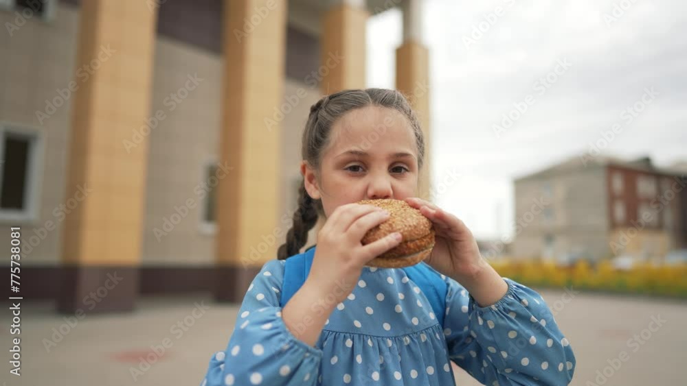 Girl having snack school.Schoolgirl takes food at recess.Happy ...
