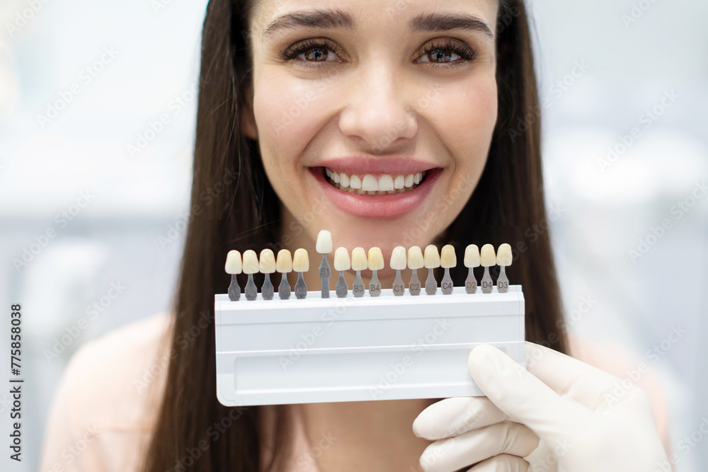 Dentist in medical gloves applying sample from tooth enamel scale to ...