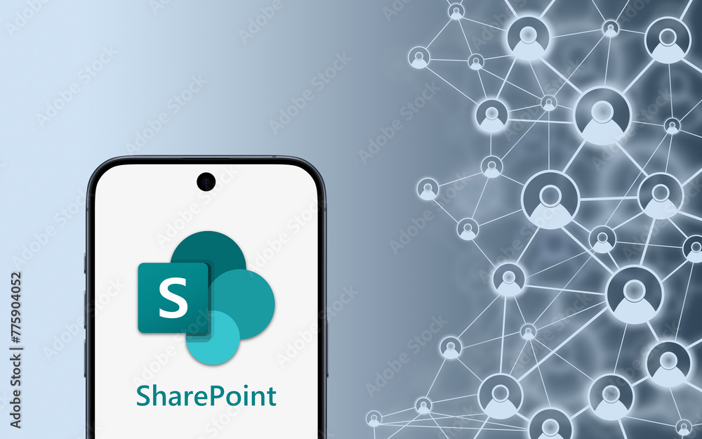 Microsoft Sharepoint logo is displayed on a smartphone, gray background ...