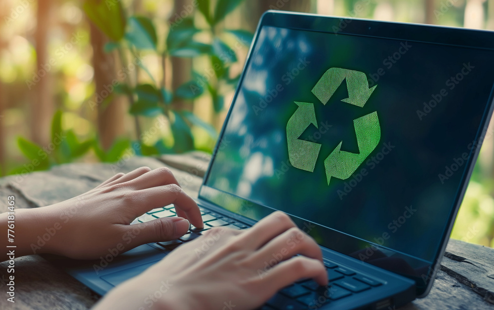 Laptop adorned with a bright green recycle symbol, emphasizing the ...