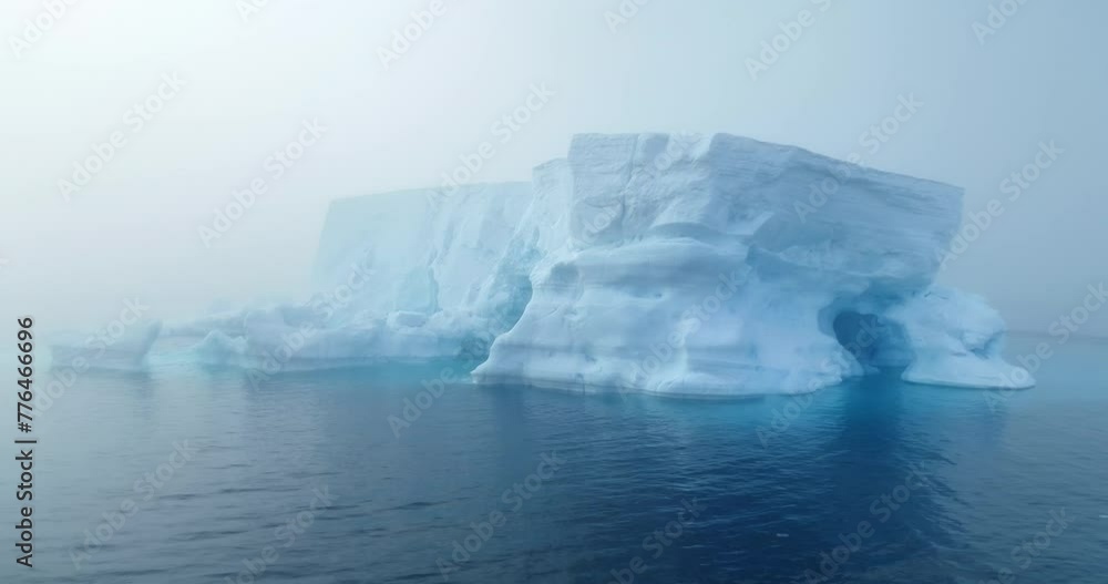 Giant iceberg drifts Antarctica ocean morning fog. Mystery dramatic mist scene. Glacier melting ...