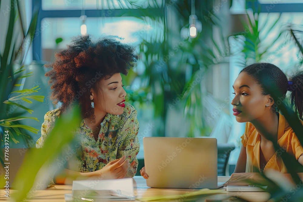 Two multiethnic female business partners are working together ...