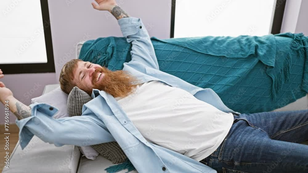 Cheerful young redhead man oozing confidence, relaxing and lying on the ...
