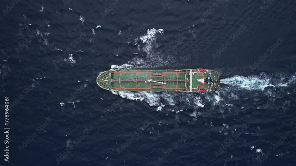 Oil products tanker sail at sea, top-down aerial trucking shot from ...