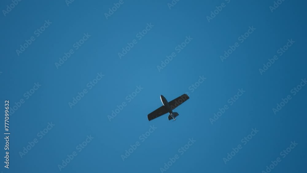 slow motion military aircraft drone is flying against backdrop of blue ...