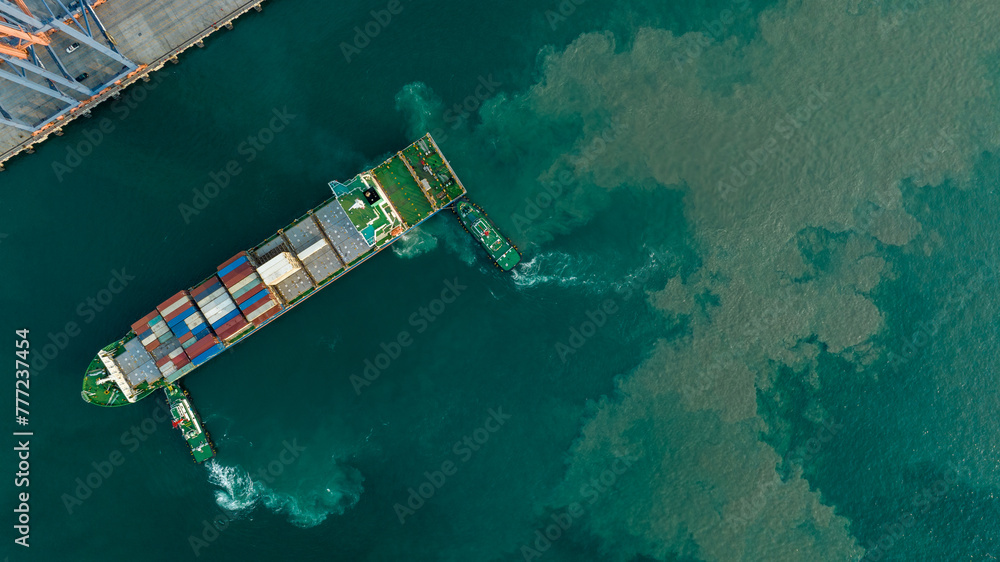Tug boat pulling Cargo Container Ship into Cargo international sea port ...
