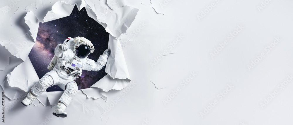 An astronaut ripping through the paper into a starry space scene ...