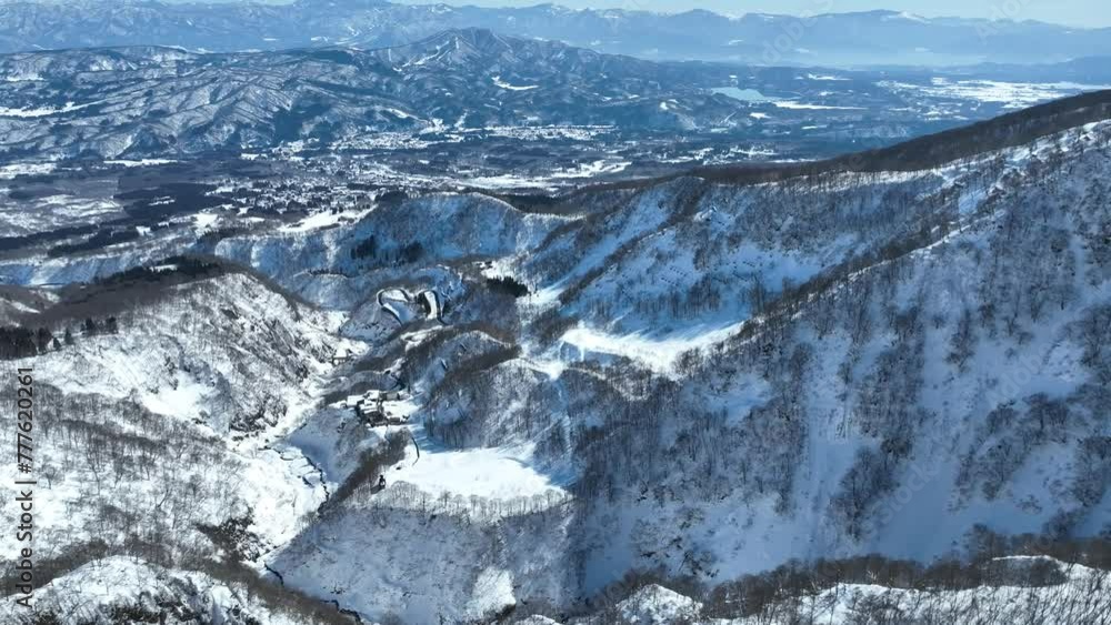 Drone shot from above snowy mountain summit, camera pushing forwards ...