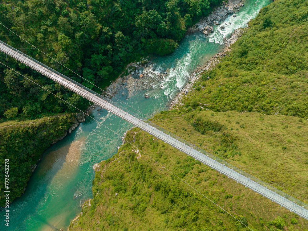 Plakát Aerial view of a Tibetan suspended bridge in Nepal is a ...