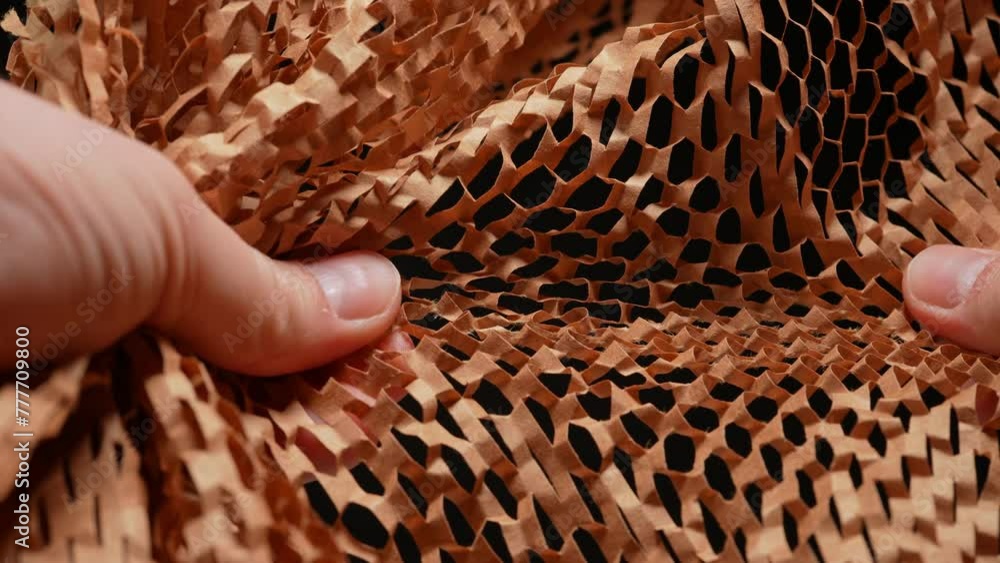 Hands crinkle and tear packaging material for parcels. Craft brown ...