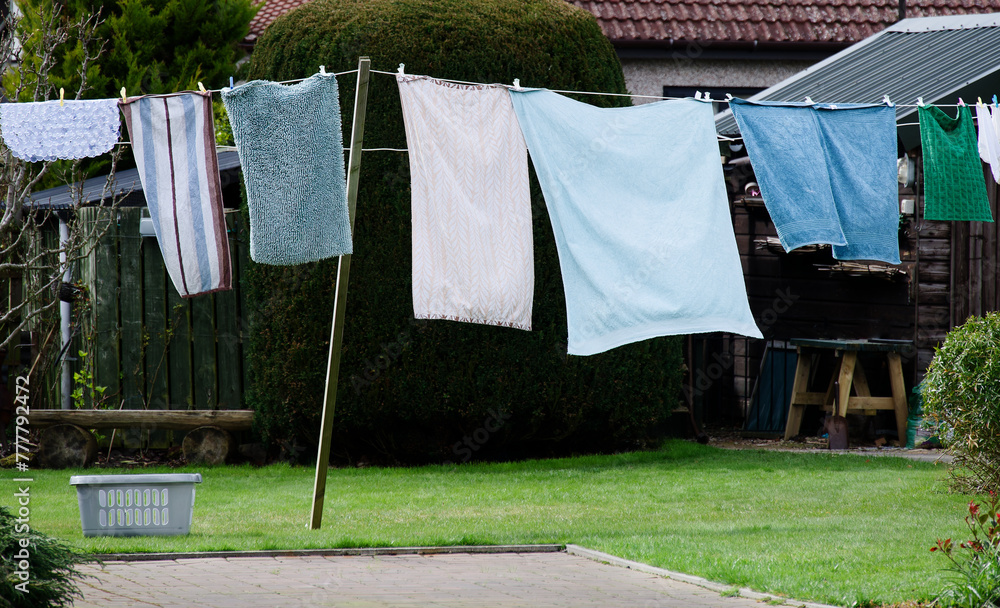 Washing line with towels drying in the garden Stock Photo | Adobe Stock
